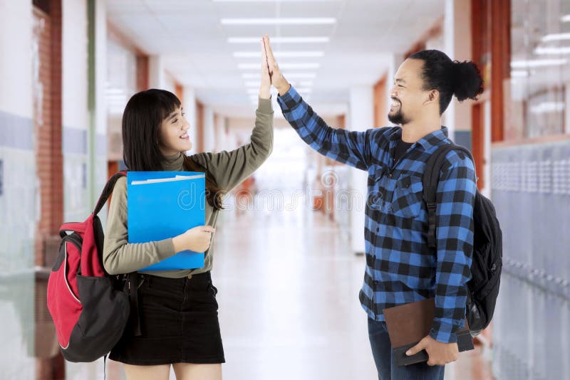 Students Give High Five in School Corridor Stock Image - Image of ...
