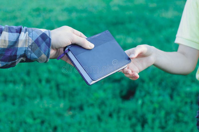 A Boy Giving a Notebook To Girl. Students Holding a Book Stock Photo ...