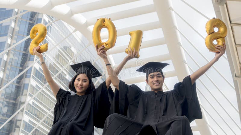 Students in Graduation Suit Sit and Gold Number Balloons 2018 Stock ...