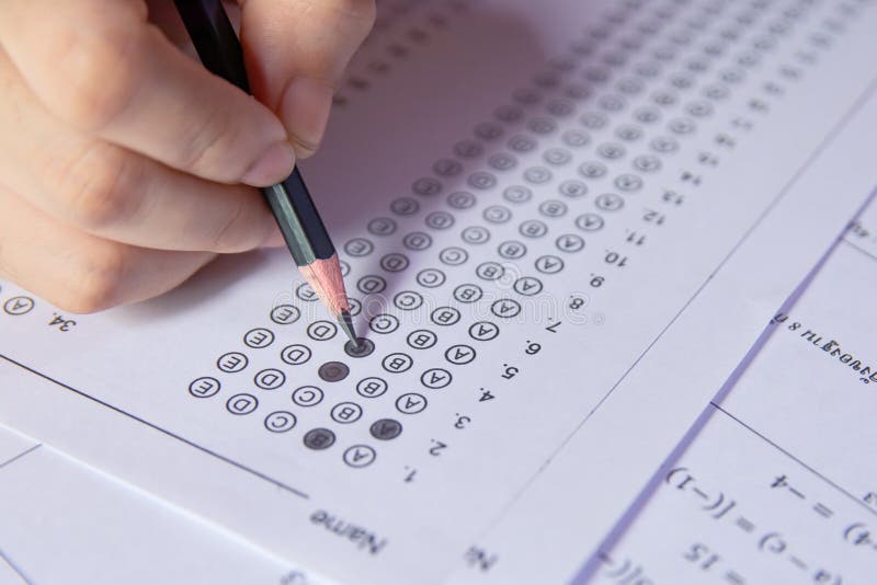 Students Hand Holding Pencil Writing Selected Choice on Answer Sheets ...