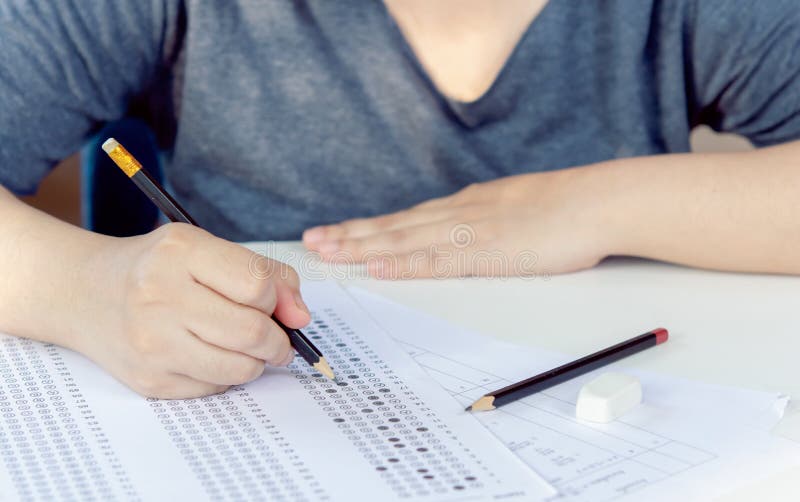 Students Hand Holding Pencil Writing Selected Choice on Answer Sheets ...