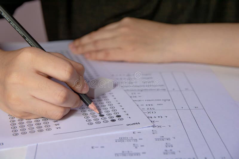 Students Hand Holding Pencil Writing Selected Choice on Answer Sheets ...
