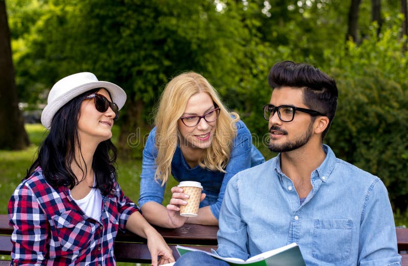 Students Having Fun while Doing Homework Together in Campus Park Stock ...