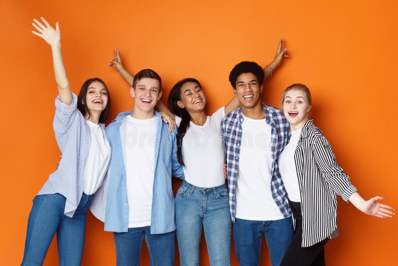 Students Having Fun Over Orange Studio Background Stock Photo - Image ...