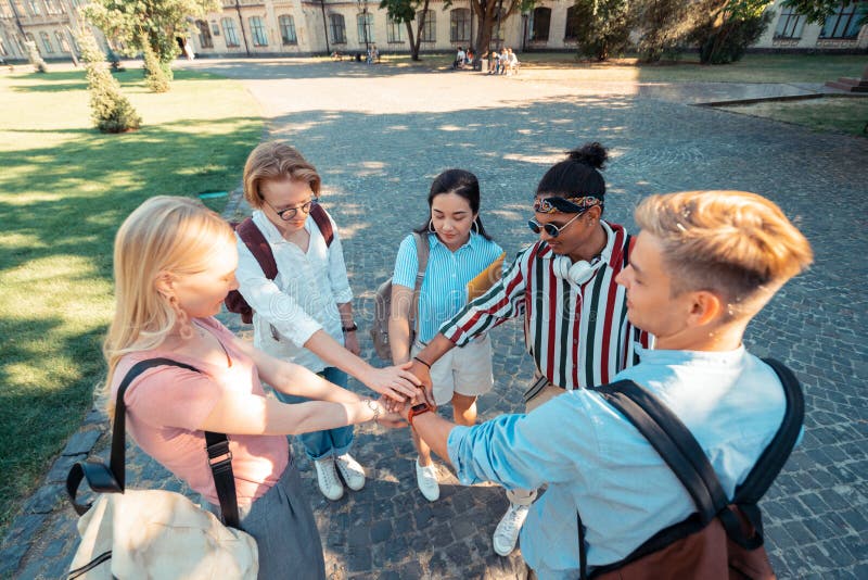 Students Holding Hands Forming a Circle in the Yard. Stock Photo ...