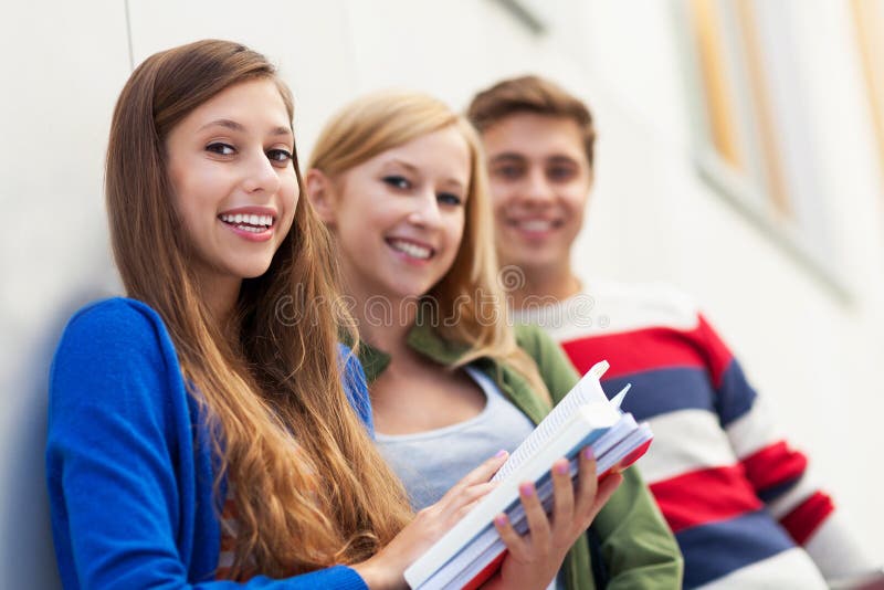 Students holding books stock image. Image of friends - 21237819