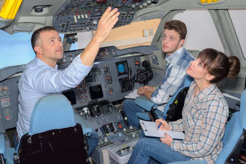 Students with Instructor in Aircraft Cockpit Stock Photo - Image of ...