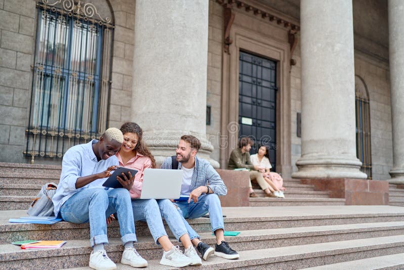 Students with a Laptop and a Digital Tablet Sitting on the Steps. Stock ...