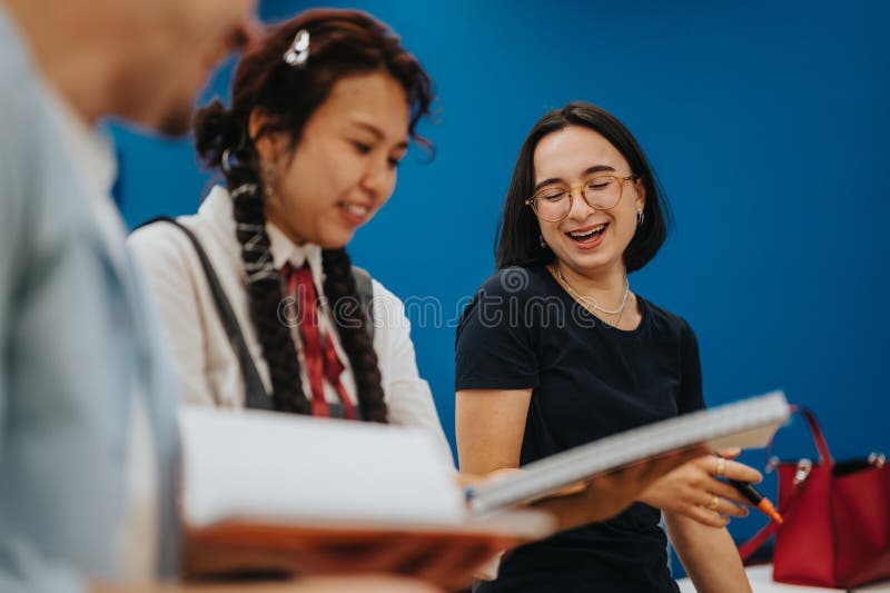 Students Laughing and Studying Together in a Bright Classroom Stock ...