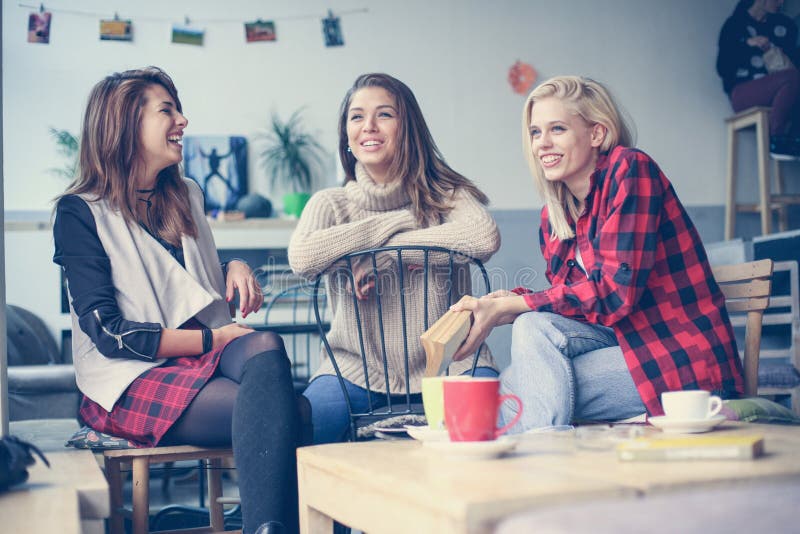 Students Learning in a Cafe. Three Friends Having Conversation Stock ... Students Learning in a Cafe. Three Friends Having Conversation Stock ...
