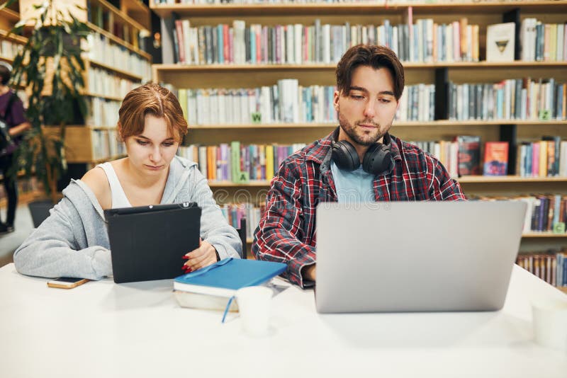 Students Learning in University Library. Young Man Preparing for Test ...