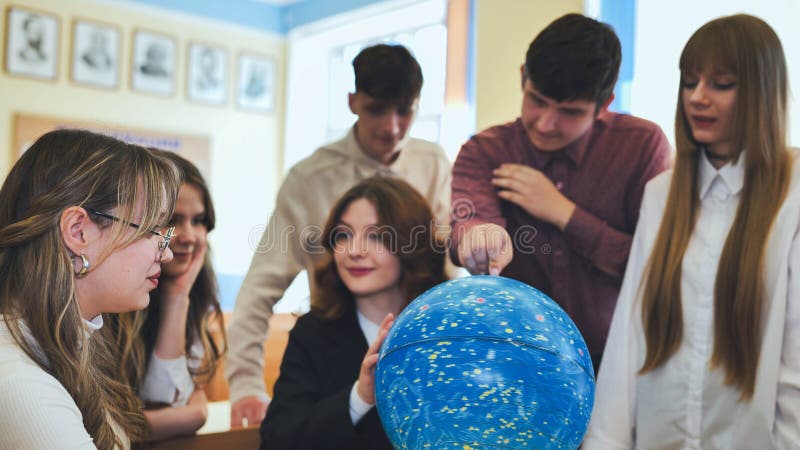 Students Look at a Globe of the Starry Sky in a Classroom at School ...