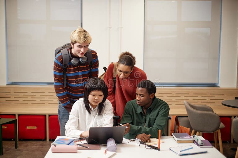 Students Looking at Laptop Screen in Library Stock Image - Image of ...