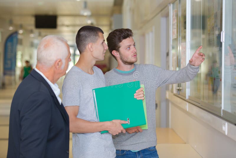 Students Looking at Notice Boards Stock Photo - Image of conversation ...