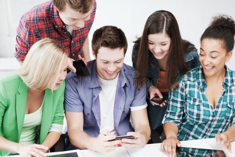 Students Looking into Smartphone at School Stock Image - Image of ...