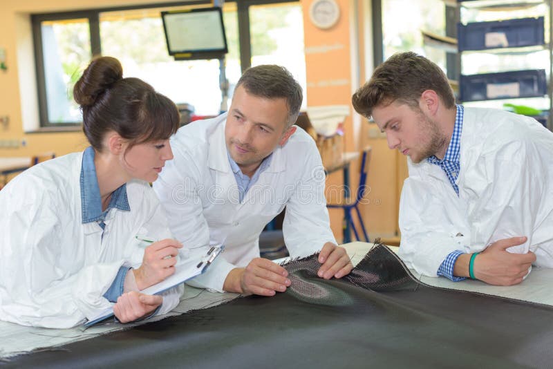Students Looking at Special Material and Taking Notes Stock Photo ...