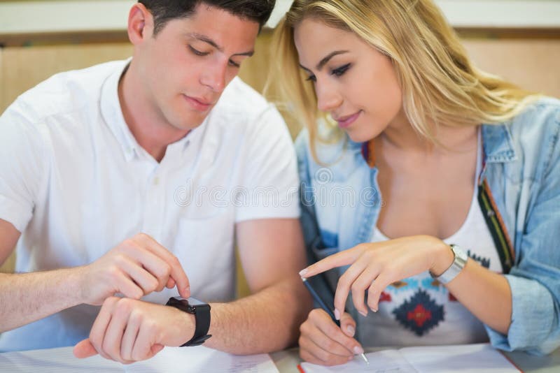 Students Looking at Watch while Studying Stock Image - Image of female ...