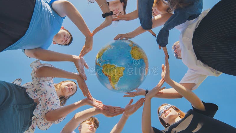Students Make a Circle Around the Globe of the World. the Concept of ...