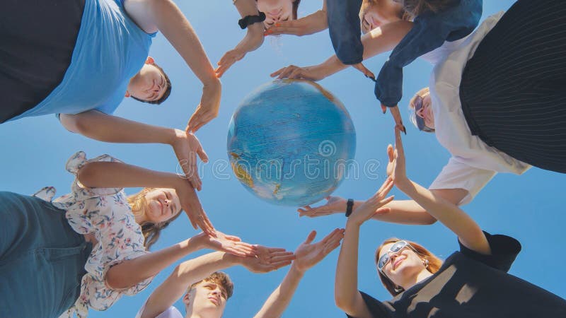 Students Make a Circle Around the Globe of the World. the Concept of ...