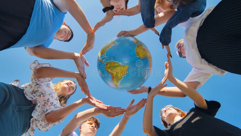 A Group of Seven College Graduates Make a Heart Shape from Their Hands ...