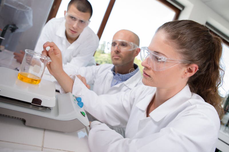 Students Making Experiments with Teacher in Laboratory Stock Photo ...