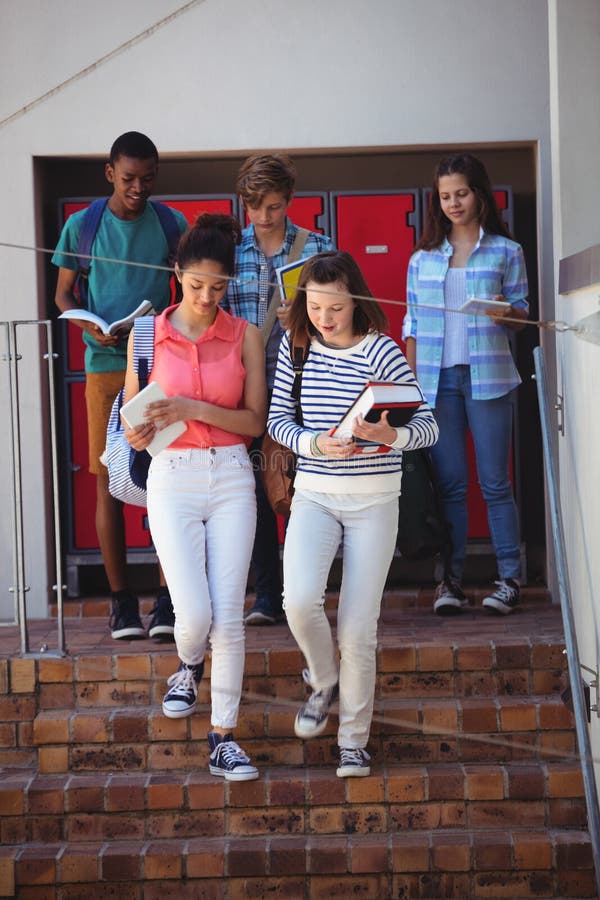 Students Moving Down Staircase Stock Photo - Image of female, lifestyle ...