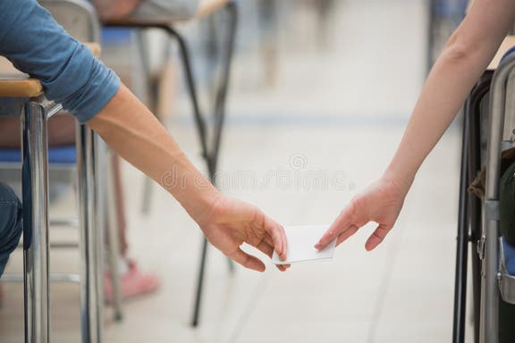 Students passing notes stock photo. Image of room, note - 31009142