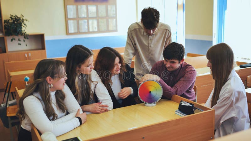 Students in Physics Class Spin Newton S Multicolored Disk. Stock Photo ...