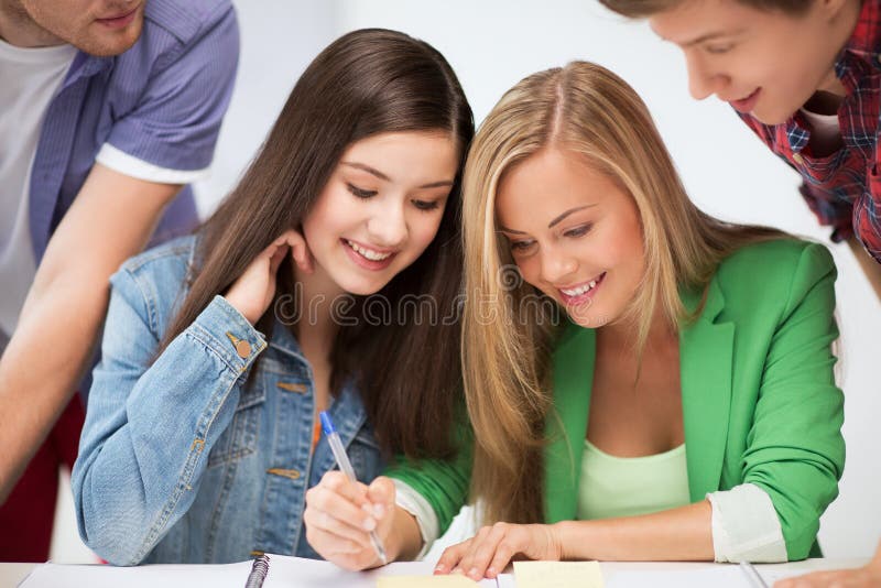 Students Pointing at Notebook at School Stock Image - Image of friendly ...