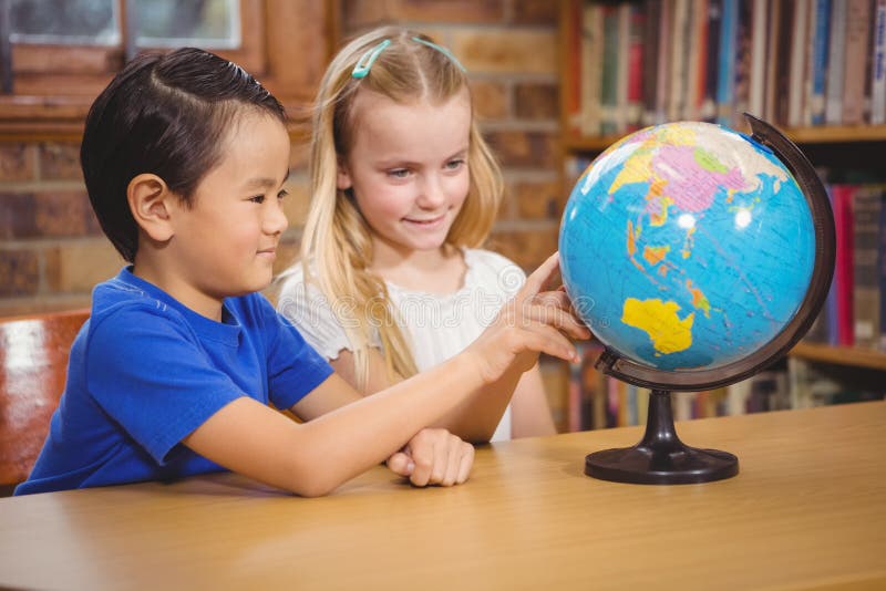 Students Pointing To Places on a Globe Stock Photo - Image of ...