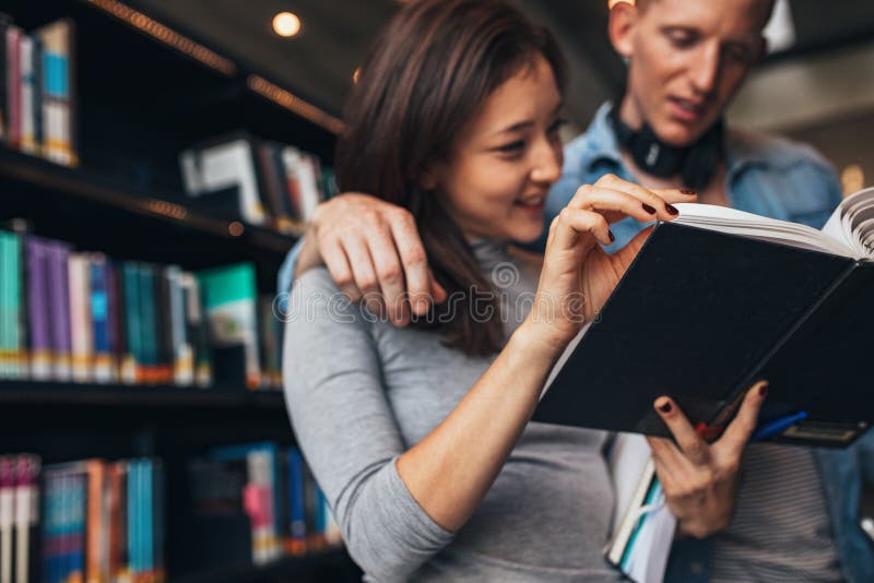 Students Reading a Book in a Library Stock Image - Image of education ...