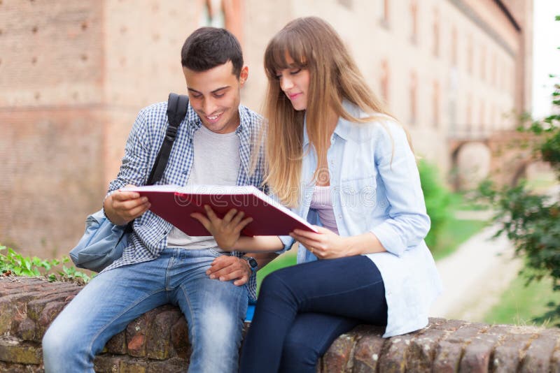 Students Reading a Book Together Stock Photo - Image of reading, teen ...