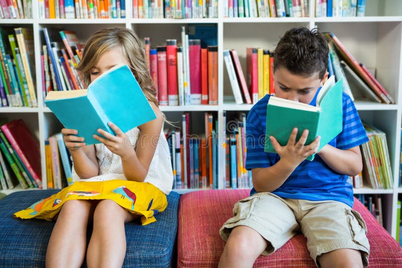 Students Reading Books while Sitting in School Library Stock Image ...