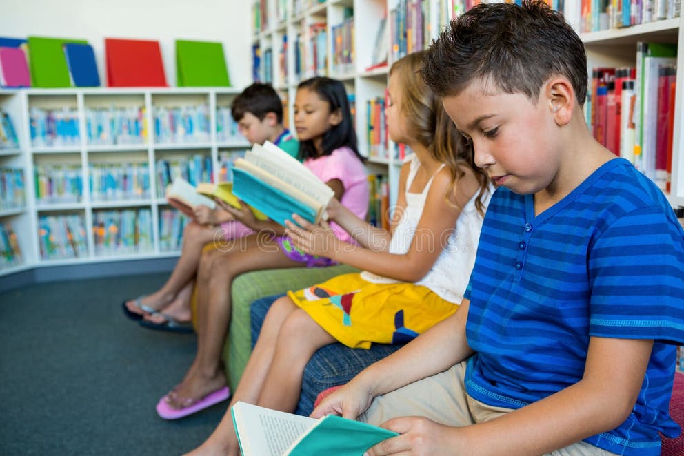 Students Reading Books while Sitting on Seats at School Library Stock ...