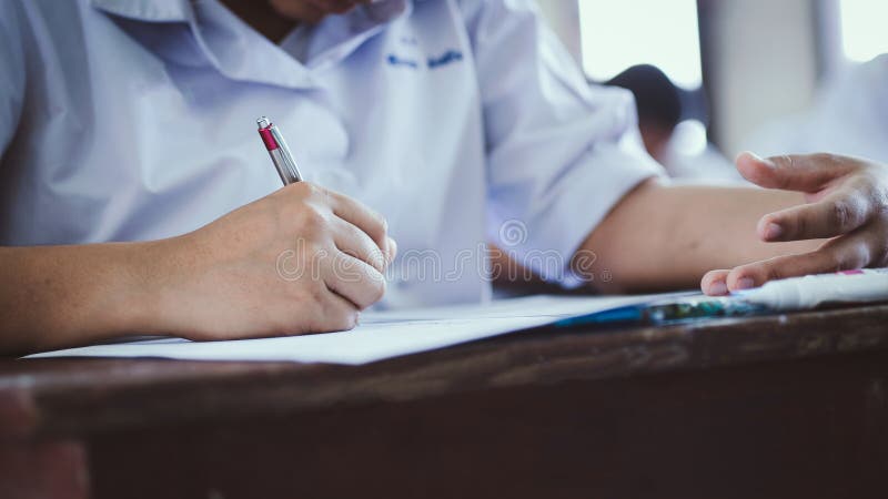 Students Reading Exam Answer Sheets Exercises in Classroom of School ...