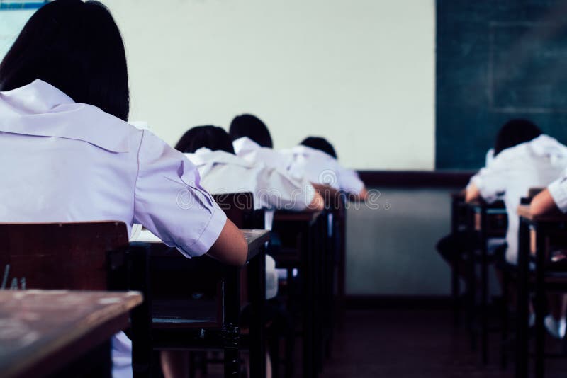 Students Reading and Writing Answer Doing Exam in Classroom Stock Image ...