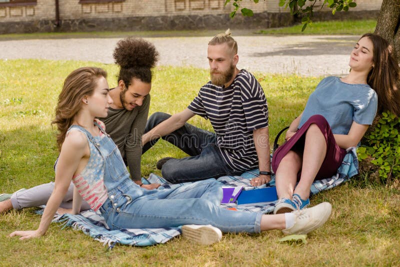 Students Relaxing on Grass. Stock Image - Image of smiling, group: 96582597
