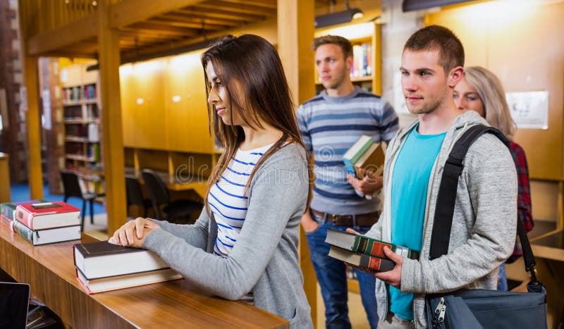Students in a Row at the Library Counter Stock Image - Image of study ...