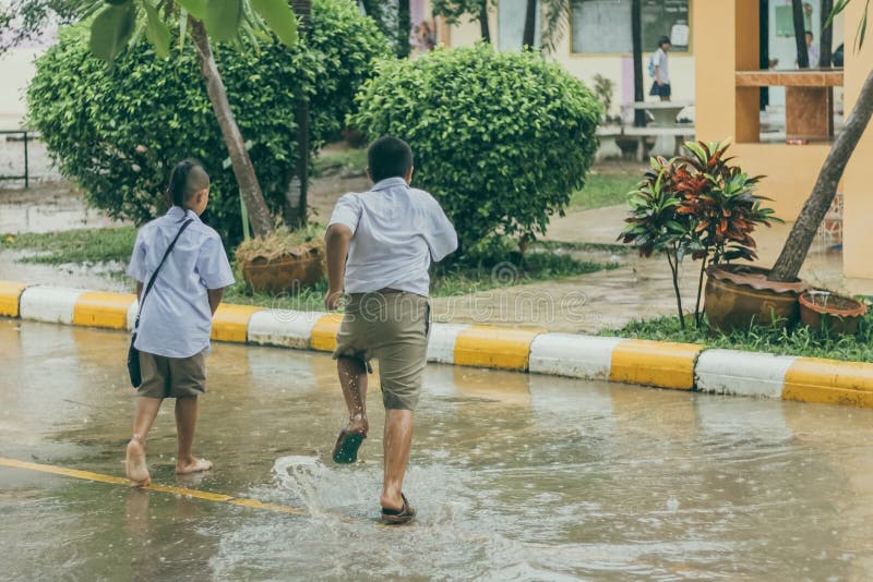 Students Rushing To Cross the Street Under Rain before Back Home ...