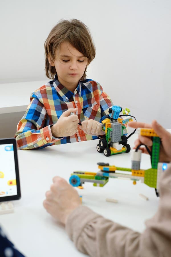 Multi Ethnic Children at Technology Lesson Coding Robot on Tablet Stock ...