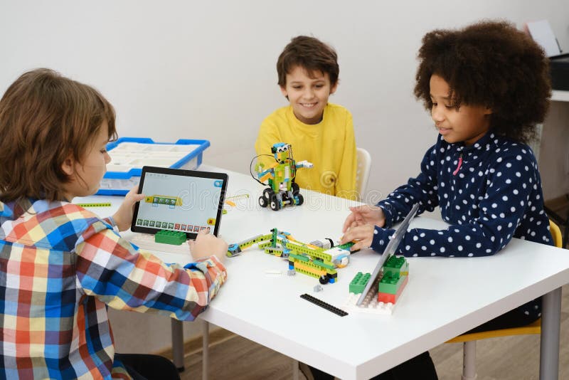 Multi Ethnic Children at Technology Lesson Coding Robot on Tablet Stock ...
