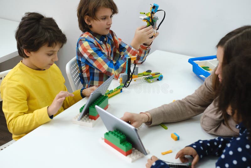 Multi Ethnic Children at Technology Lesson Coding Robot on Tablet Stock ...