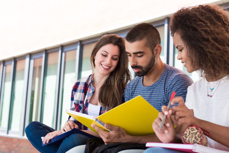 Students sharing notes stock photo. Image of books, school - 56738172