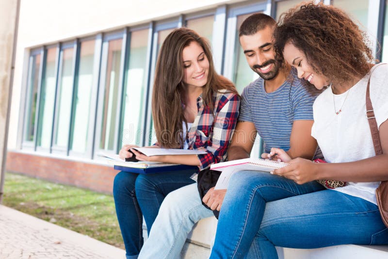 Students sharing notes stock image. Image of graduation - 56739853