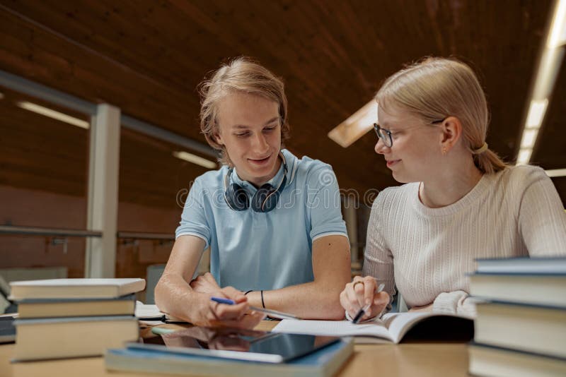 Students Sit in the Library and Take Notes while Preparing for the Exam ...