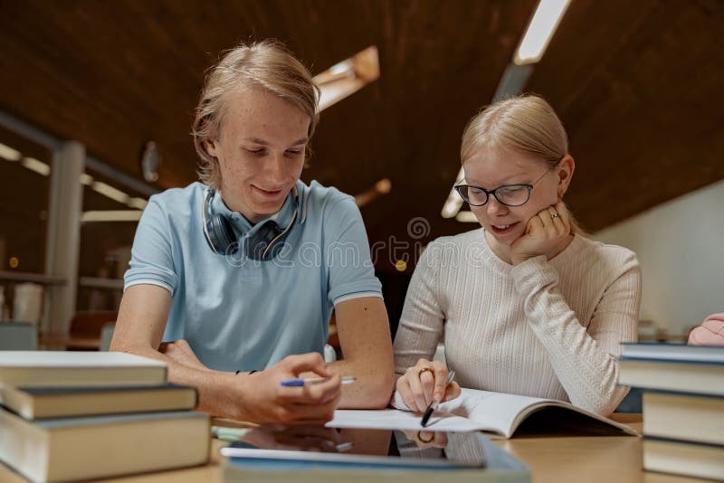 Students Sit in the Library and Take Notes while Preparing for the Exam ...