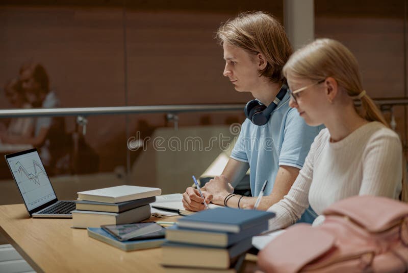 Students Sit in the Library and Take Notes while Preparing for the Exam ...