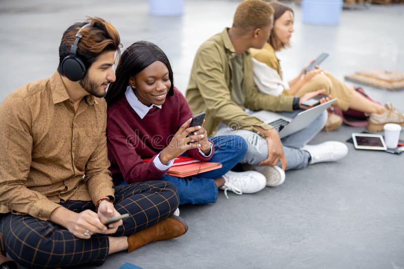 Students Sit and Use Digital Devices on Asphalt Stock Photo - Image of ...