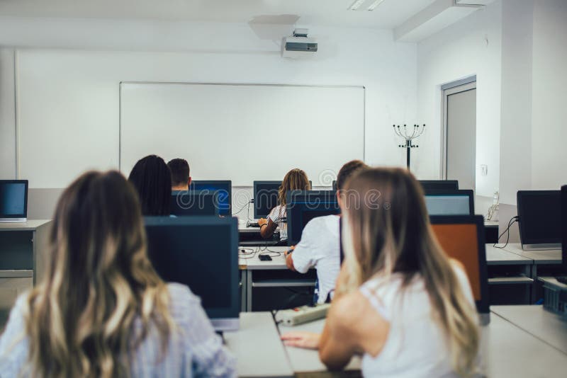 Students Sitting in a Classroom, Using Computers during Class Stock ...
