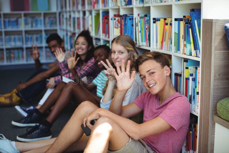 Students Sitting in Library and Waving Hands Stock Image - Image of ...
